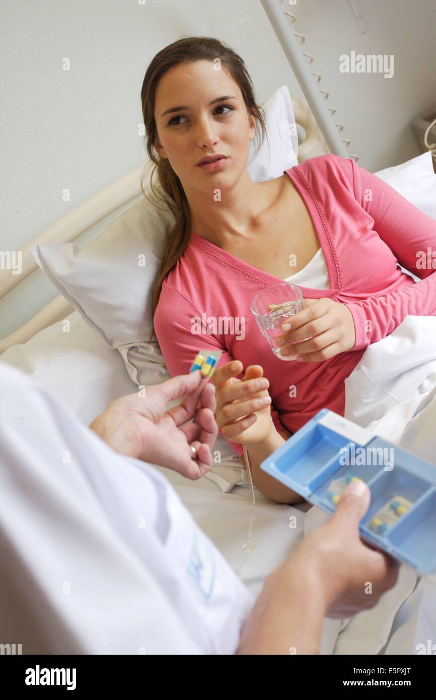 Nurse giving medication to a female patient at hospital Stock Photo - Alamy