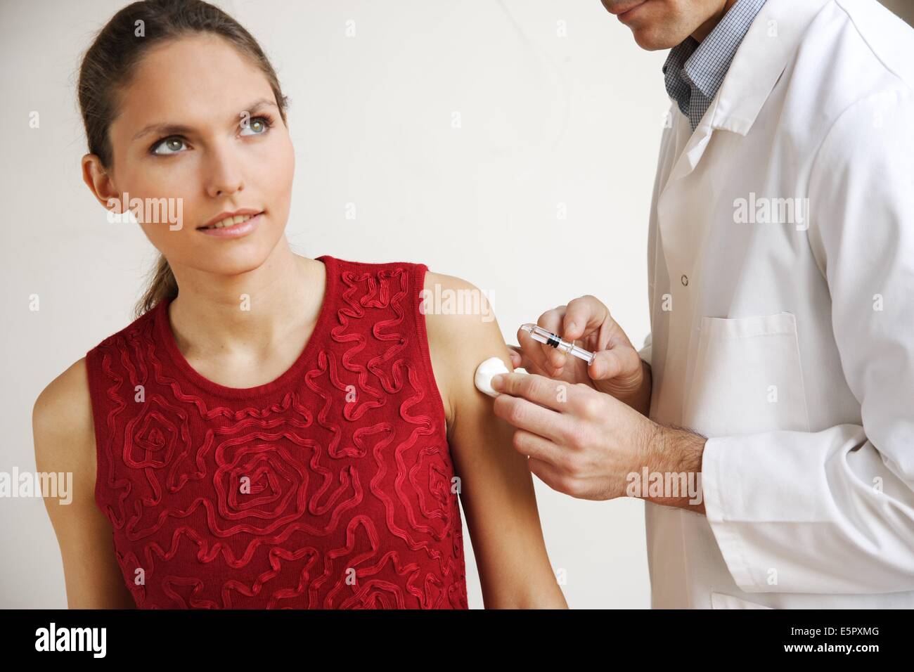 Woman receiving vaccination Stock Photo - Alamy