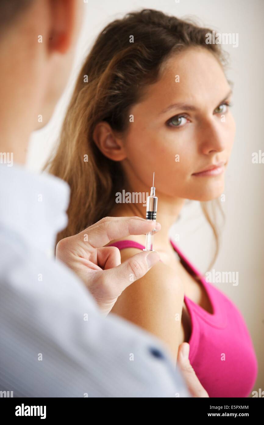 Woman receiving vaccination Stock Photo - Alamy