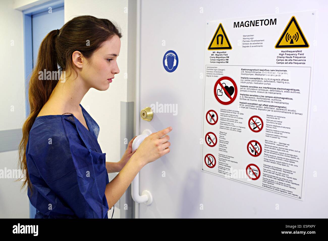 Patient reading warning instructions posted on the MRI (Magnetic ...