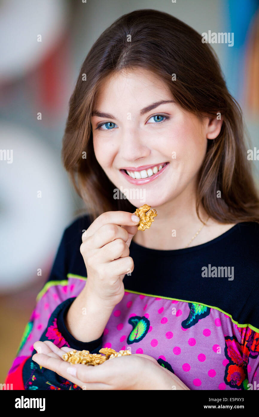 Woman eating walnuts Stock Photo - Alamy