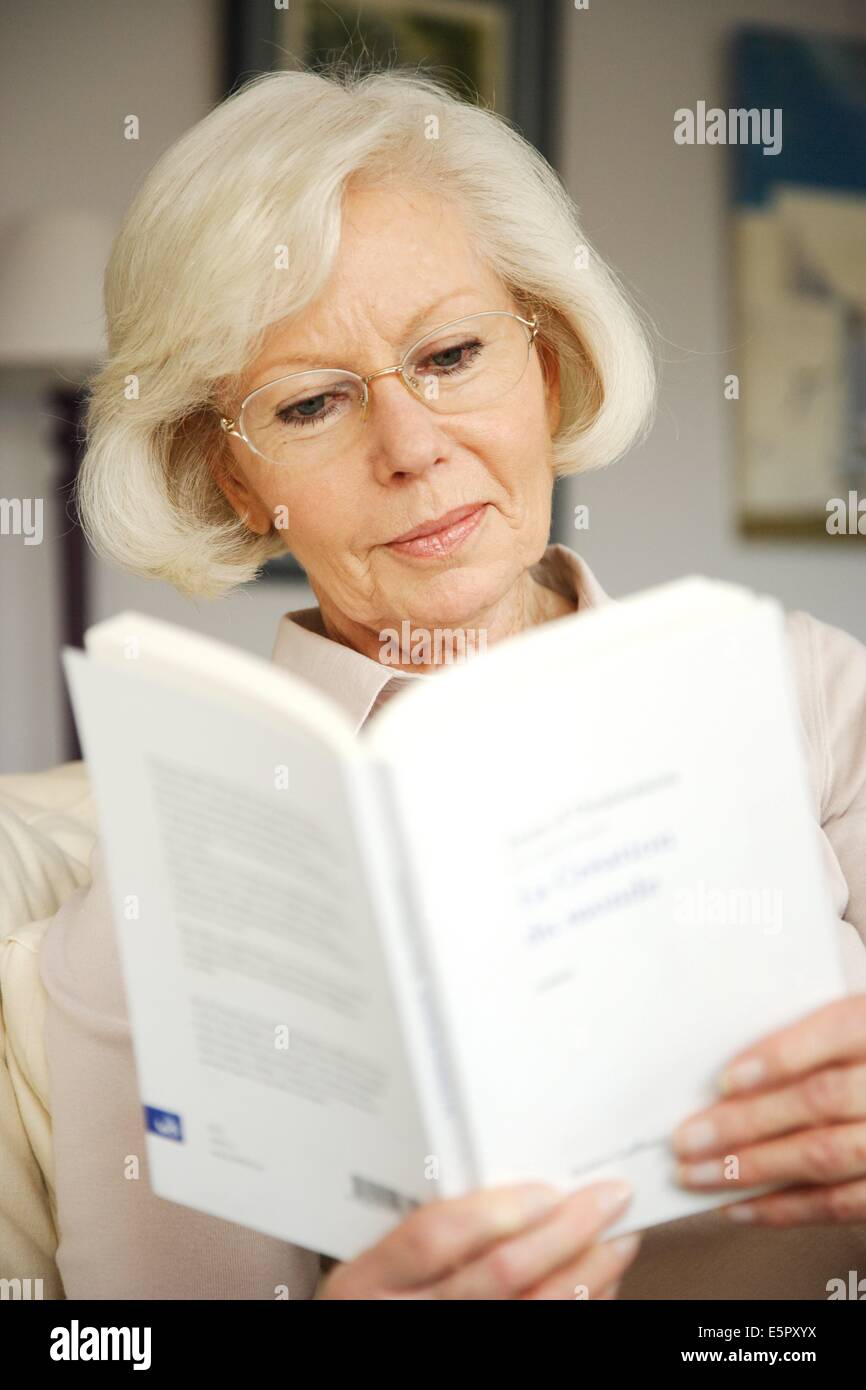 Elderly person reading book Stock Photo - Alamy