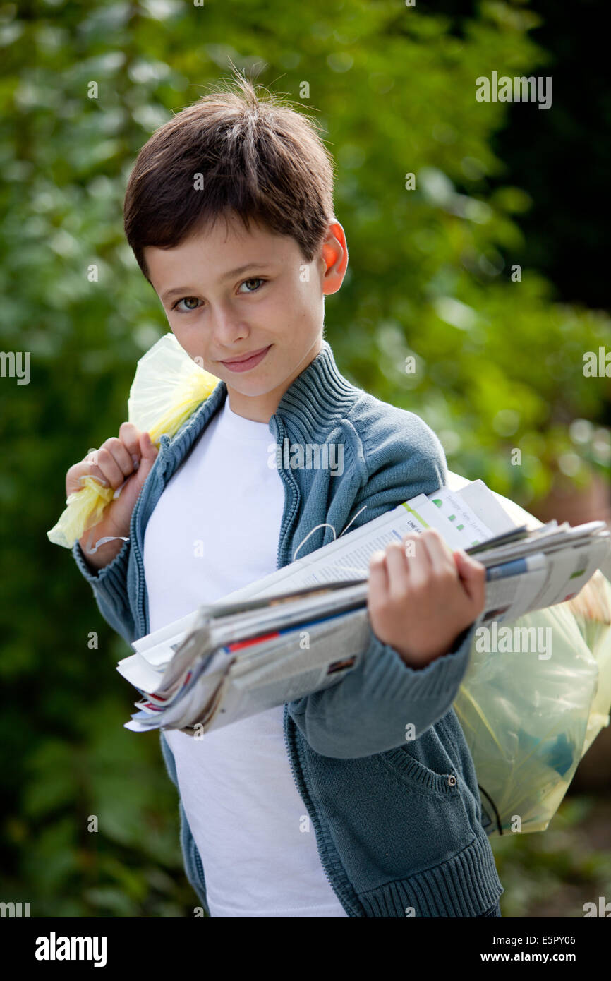 Boy throwing recycled wastes Stock Photo - Alamy