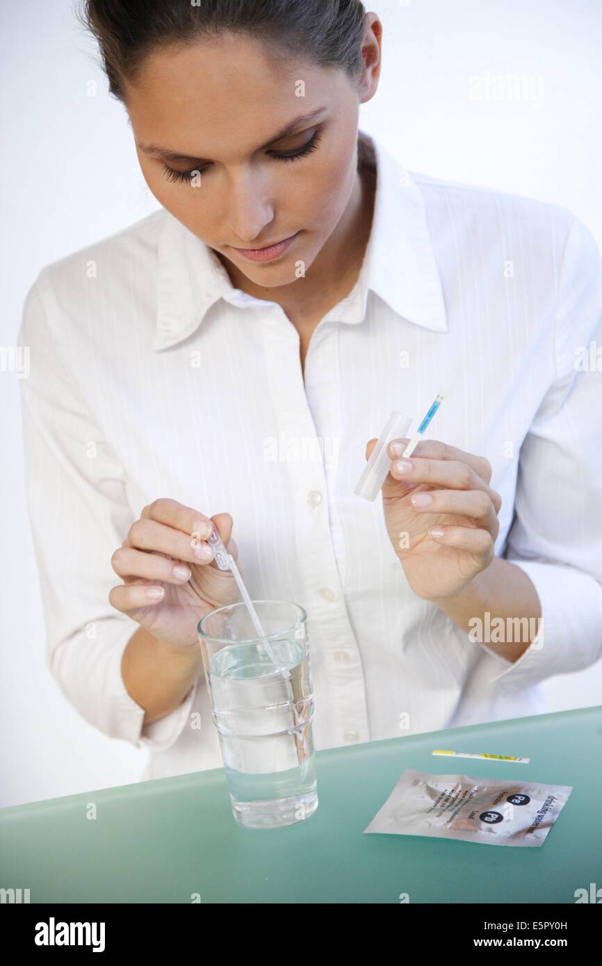 Water analysis, Woman testing the quality of tap water Stock Photo - Alamy