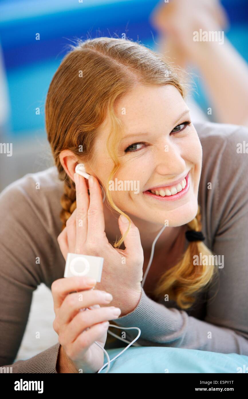 Woman listening to music with a MP3 player Stock Photo - Alamy