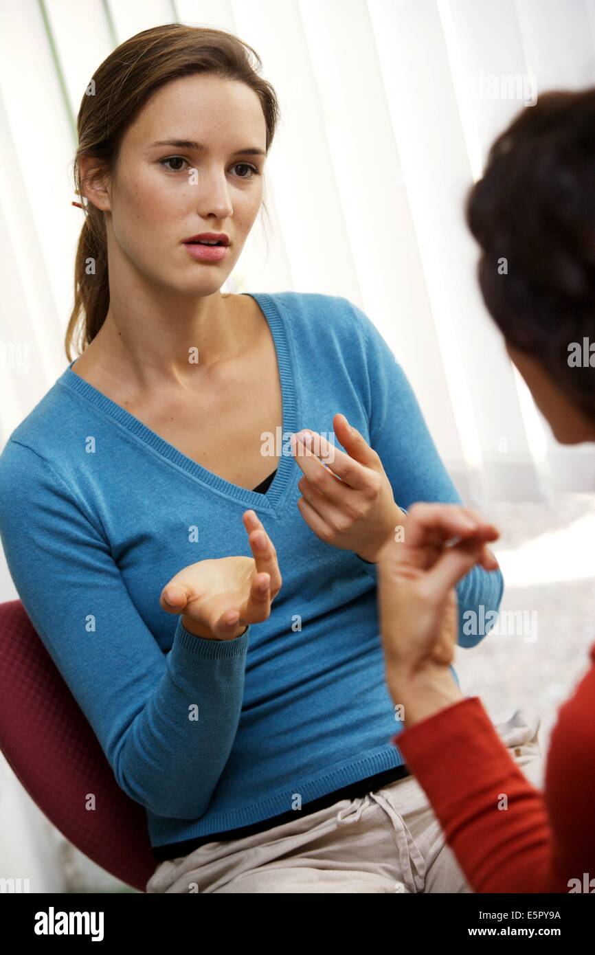 Two women talking Stock Photo - Alamy