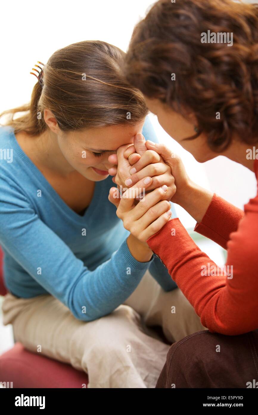 Woman consoling young woman Stock Photo - Alamy