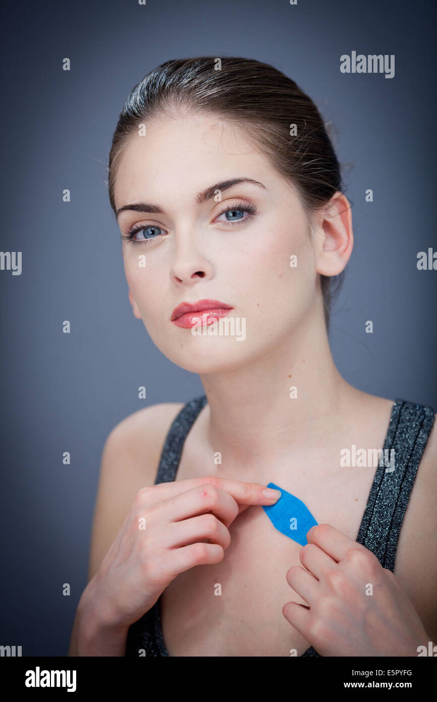 Woman putting a band-aid Stock Photo - Alamy
