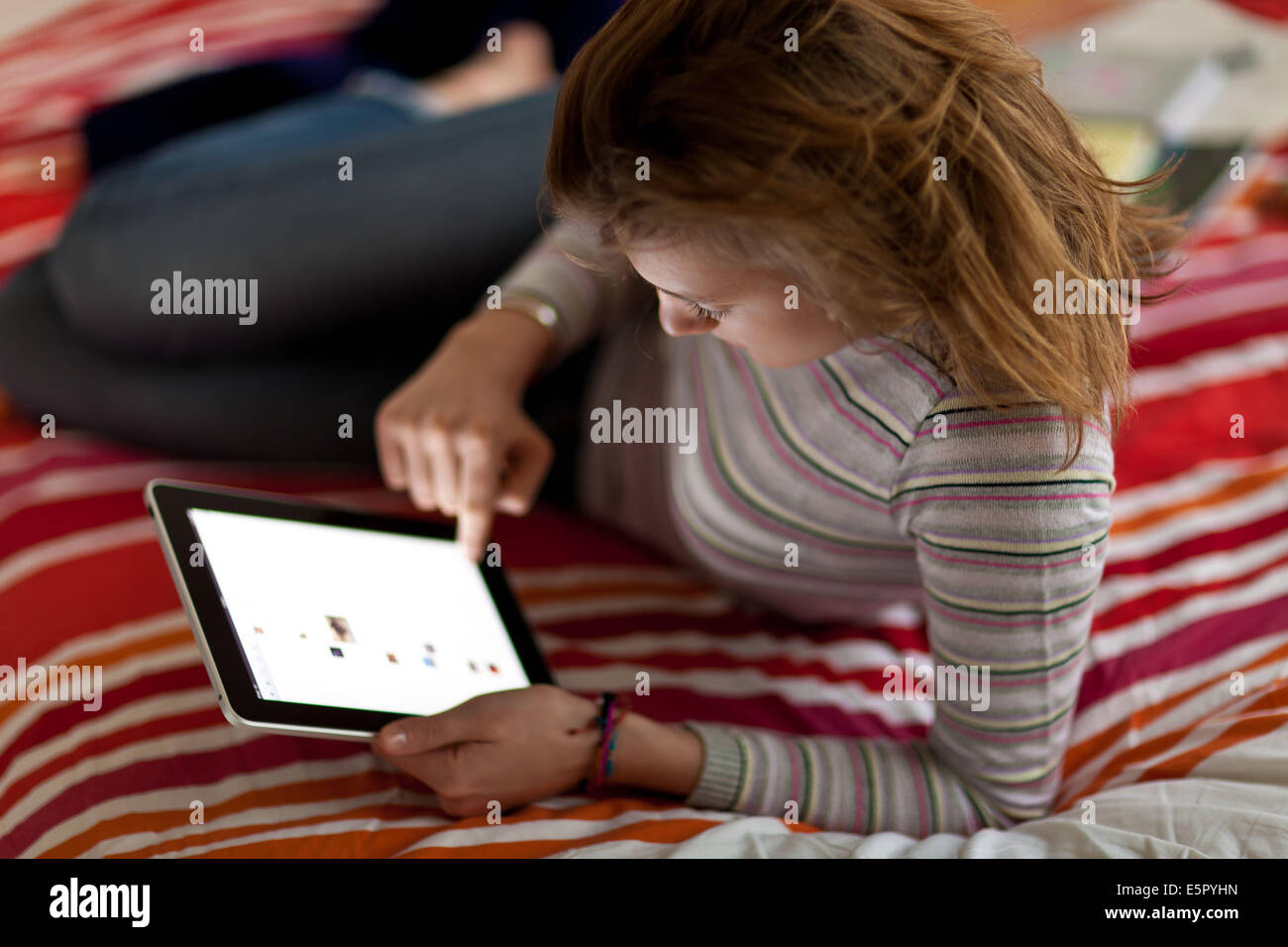 Teenage girl using iPad ® Stock Photo - Alamy