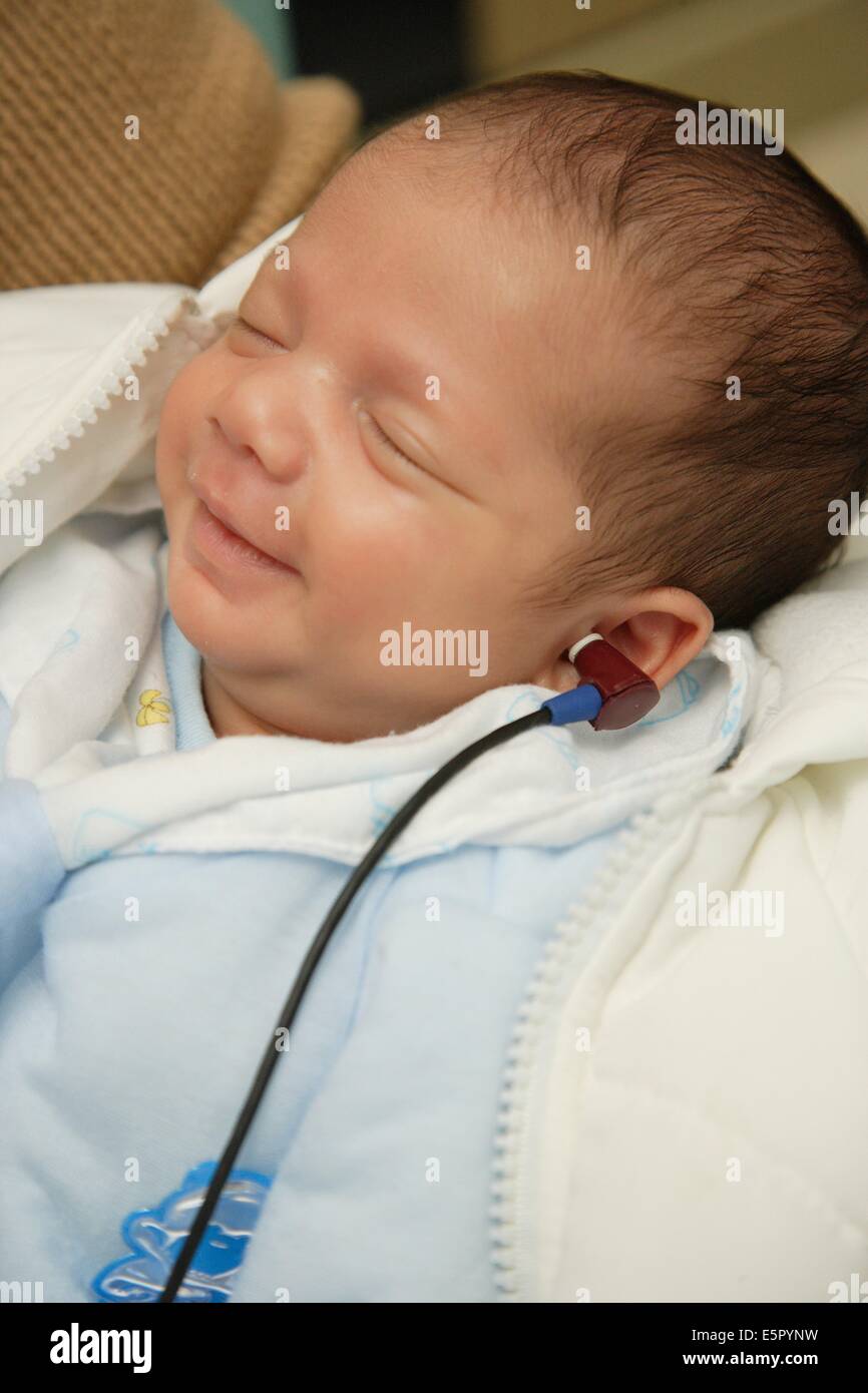 Baby undergoing deafness screening test with the method of otoacoustic ...