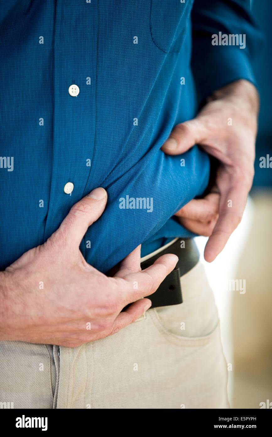 Man squeezing waist hi-res stock photography and images - Alamy