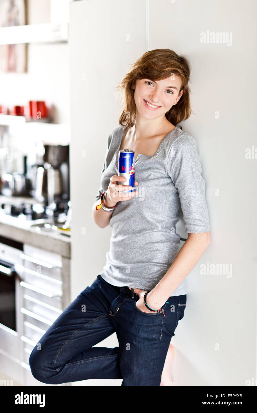 Teenage girl drinking Red Bull® : taurine and cafeine-based energy ...