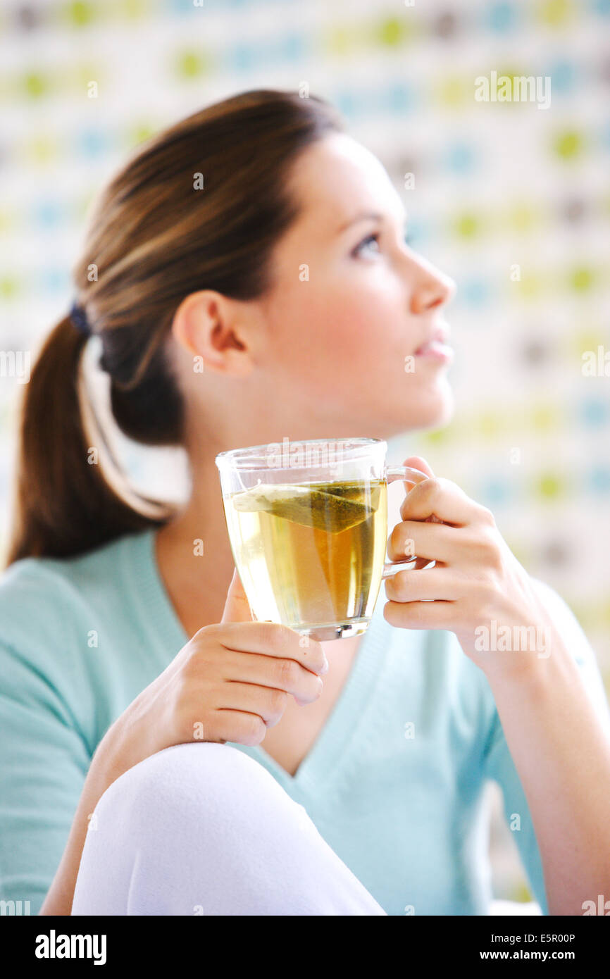 Woman drinking hot beverage Stock Photo - Alamy