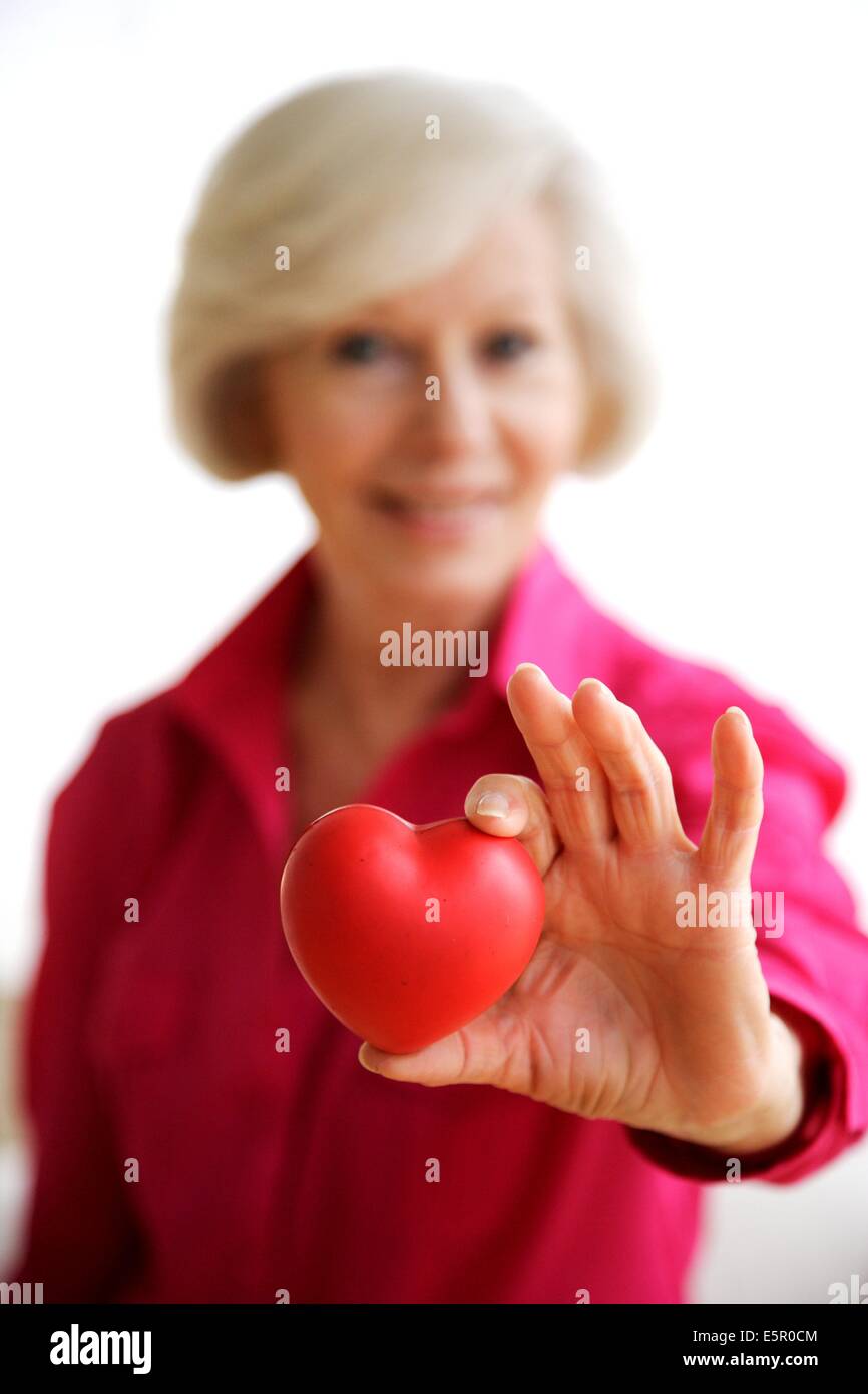 Woman holding heart Stock Photo - Alamy