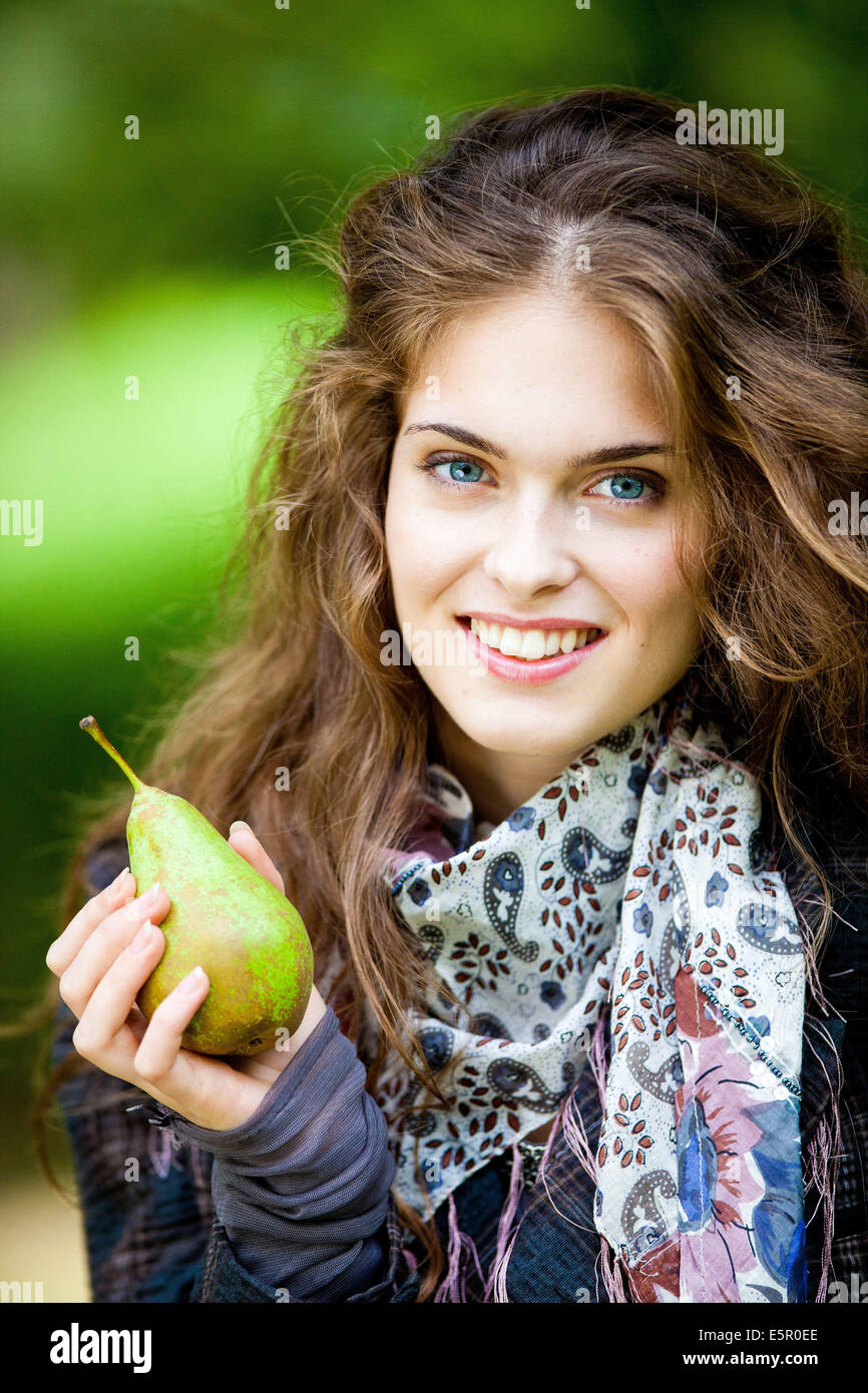 Woman eating a pear Stock Photo - Alamy