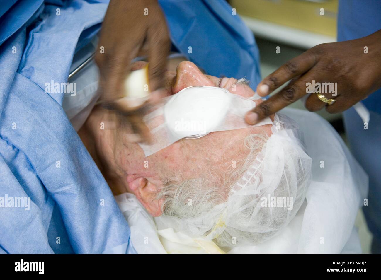 Patient with eye bandaid after cataract surgery Stock Photo - Alamy