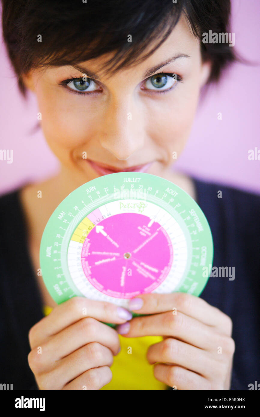 Woman using a conception chart to determine the term of pregnancy Stock ...