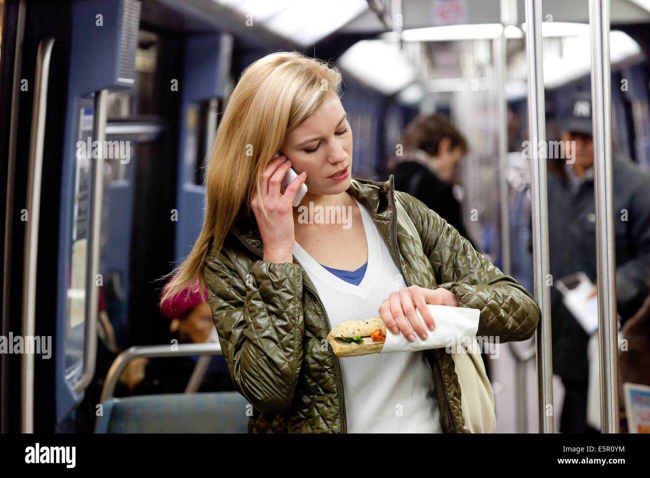 Woman eating a sandwich in the subway Stock Photo - Alamy