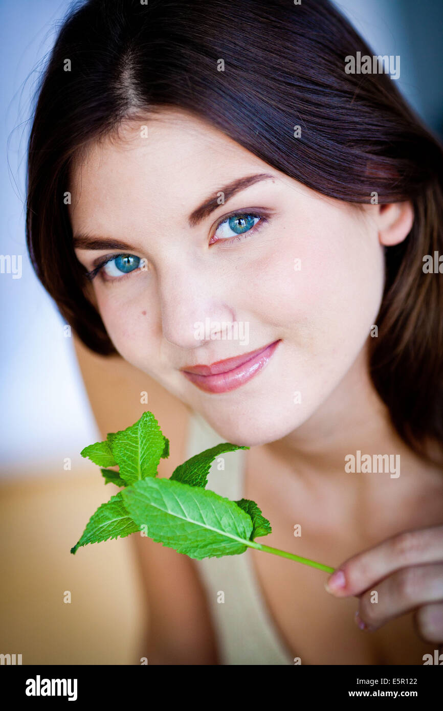 Woman smelling mint leaves (Mentha sp Stock Photo - Alamy