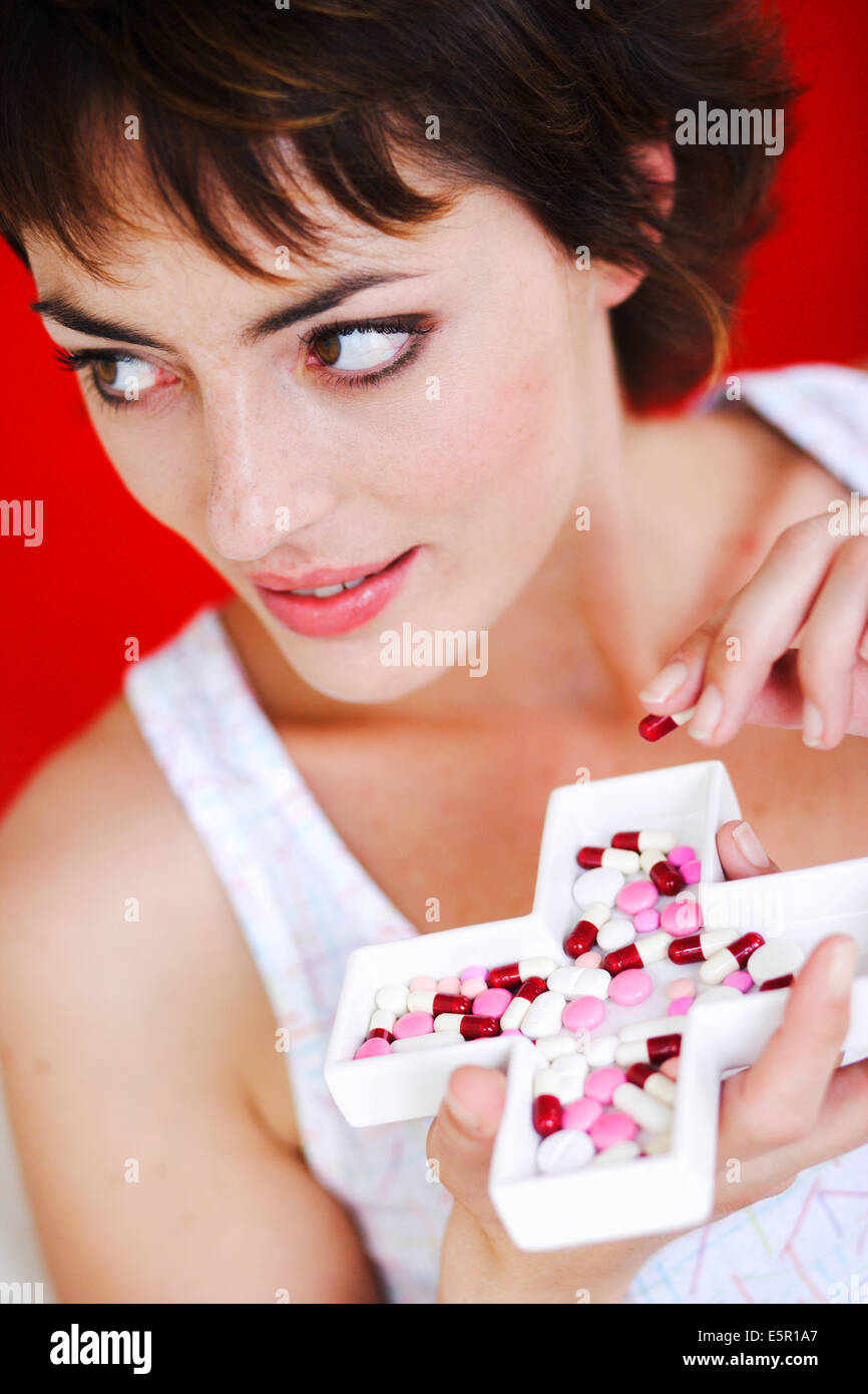 Woman taking medicine Stock Photo - Alamy