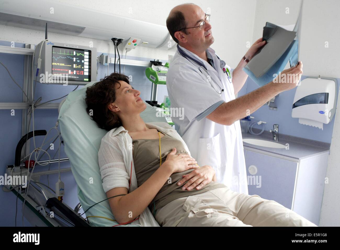 Hospital doctor showing X-ray with a patient in observation at ...