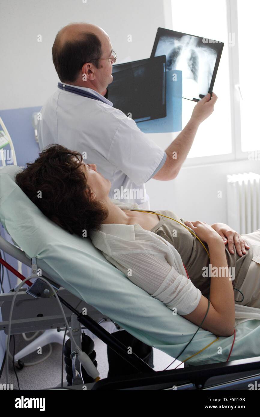 Hospital doctor showing X-ray with a patient in observation at ...