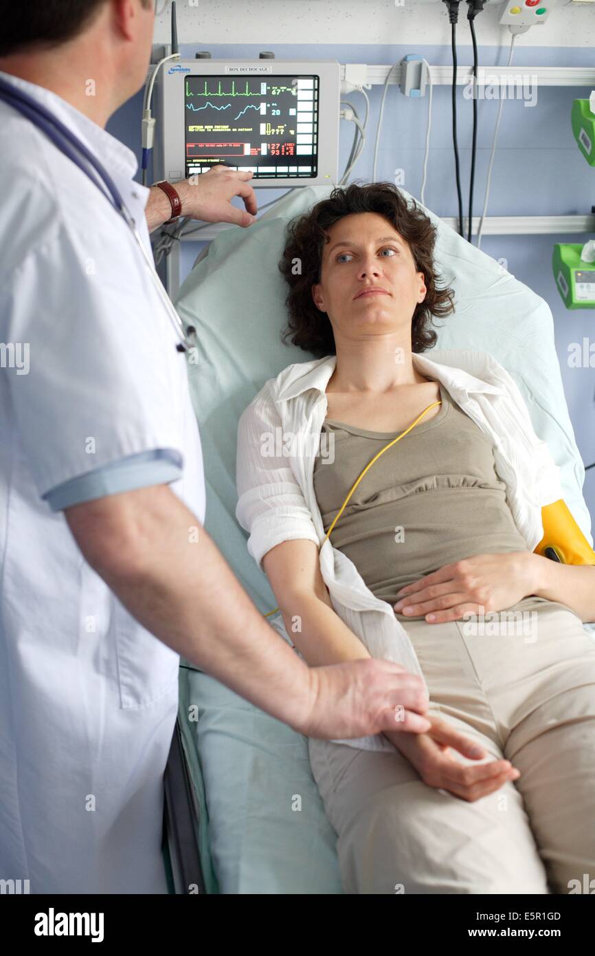 Hospital doctor talking with a patient in observation at emergency ...