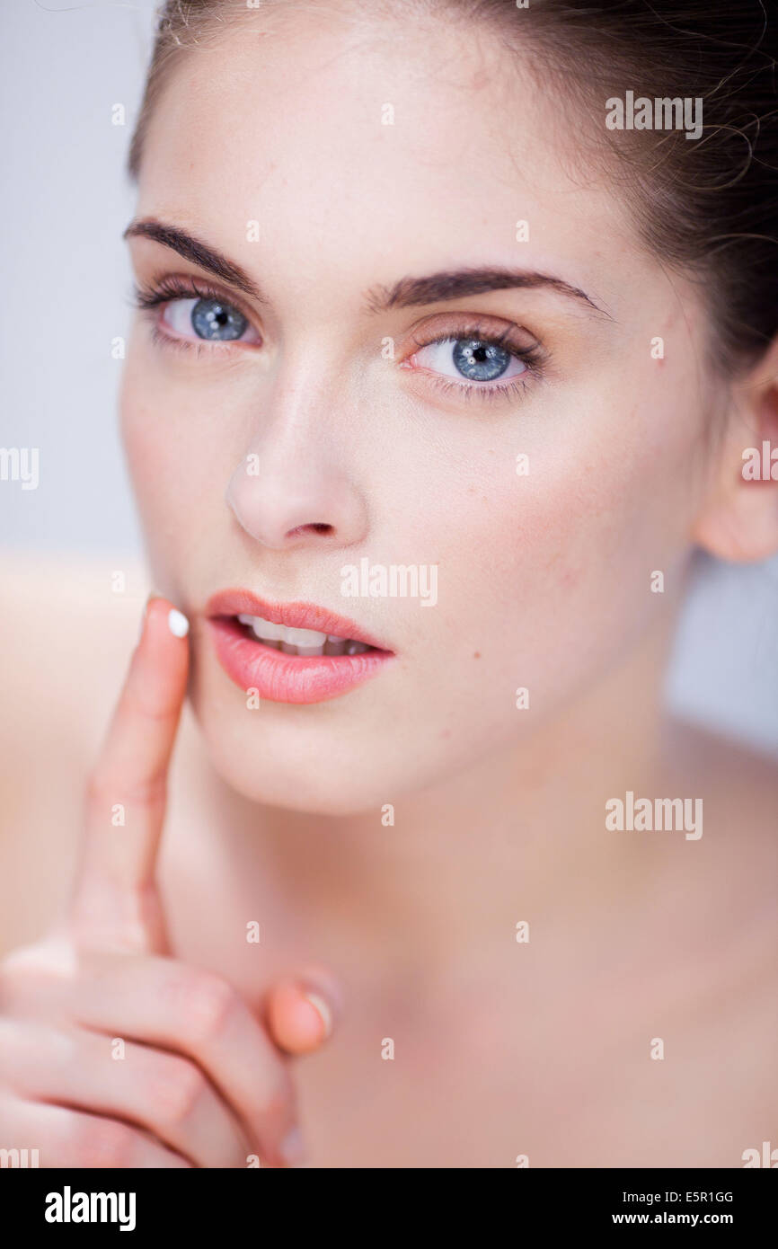 Woman applying cream on her lips as a treatment for a cold sore Stock ...