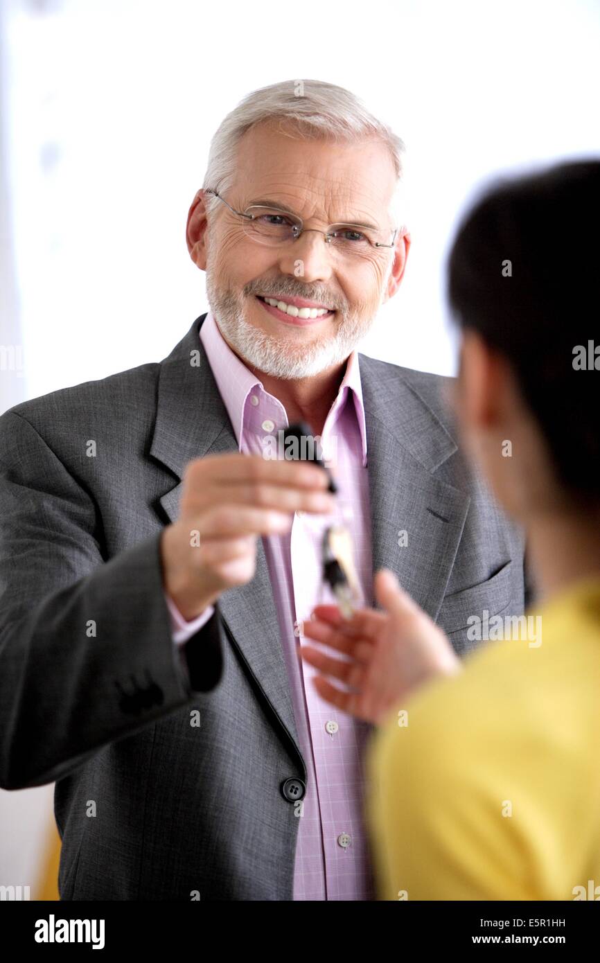 Senior man passing keys Stock Photo - Alamy