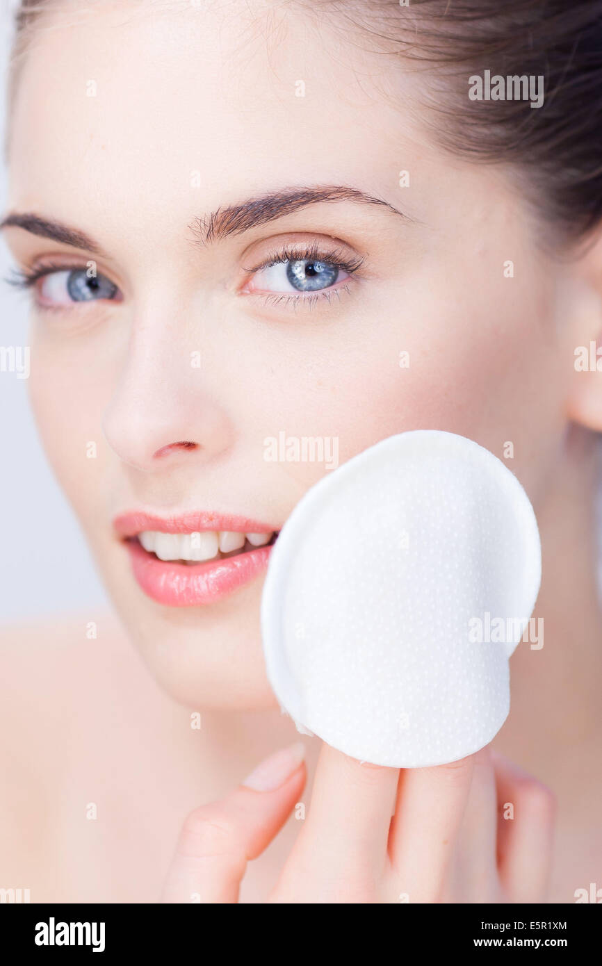 Woman removing make-up Stock Photo - Alamy