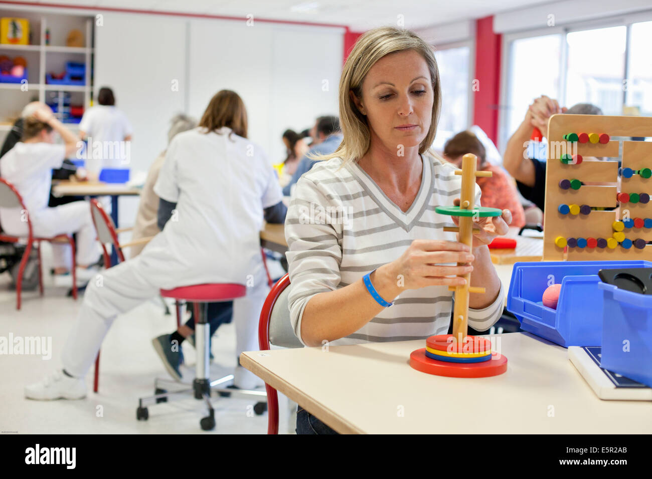 Functional rehabilitation of paralyzed on one side woman (model ...
