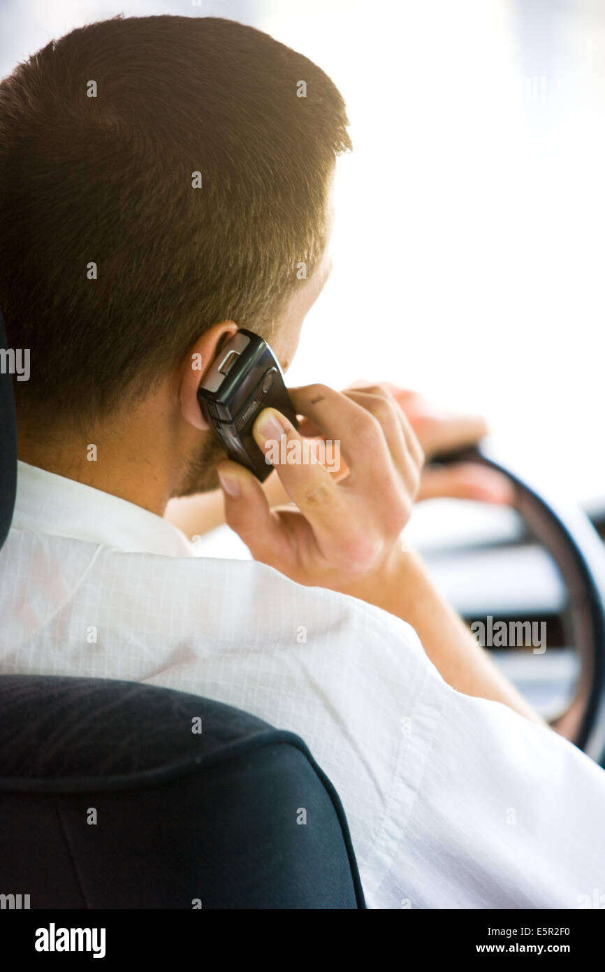 Man using a cell phone while driving Stock Photo - Alamy