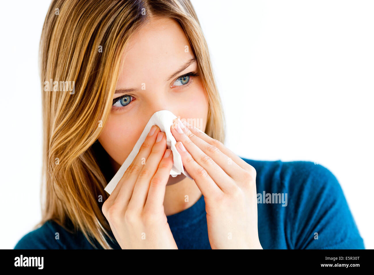 Woman blowing her nose Stock Photo - Alamy