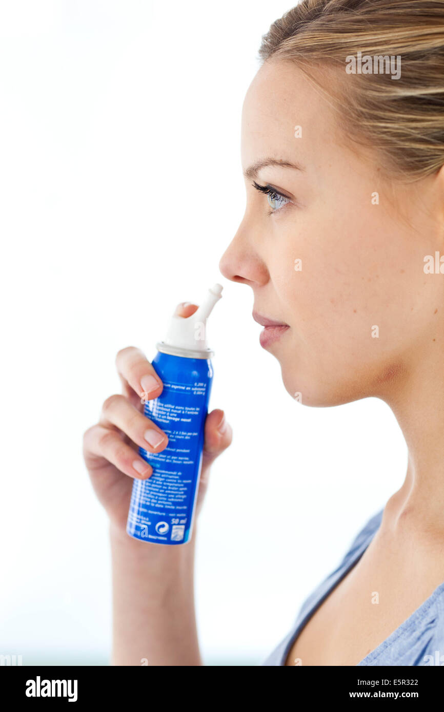 Woman using a sterile sea water spray Stock Photo - Alamy