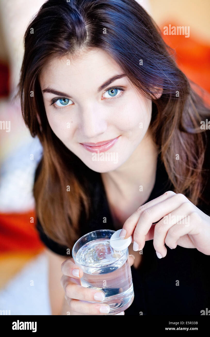 Woman taking an effervescent aspirin tablet Stock Photo - Alamy