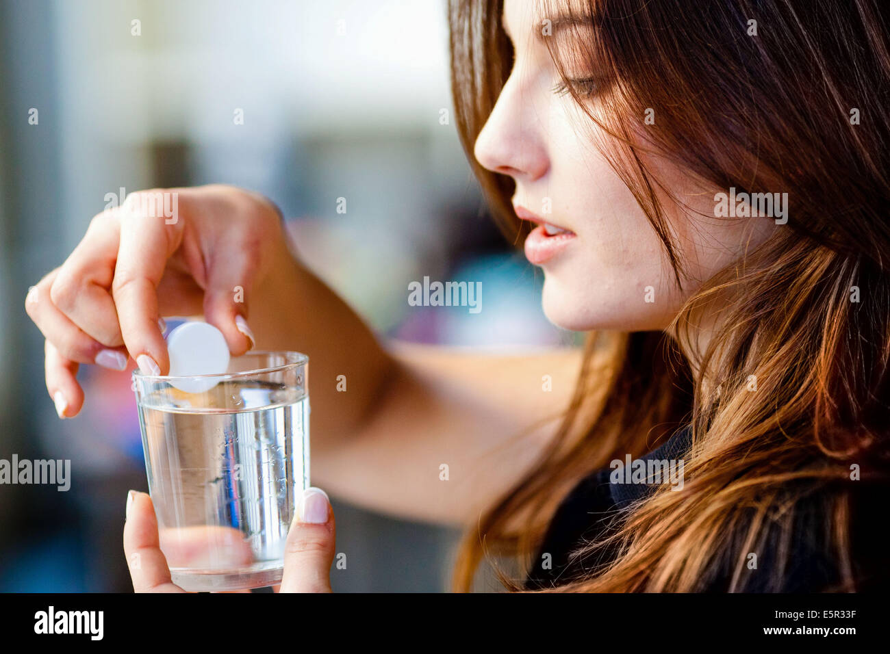 Woman taking an effervescent aspirin tablet Stock Photo - Alamy