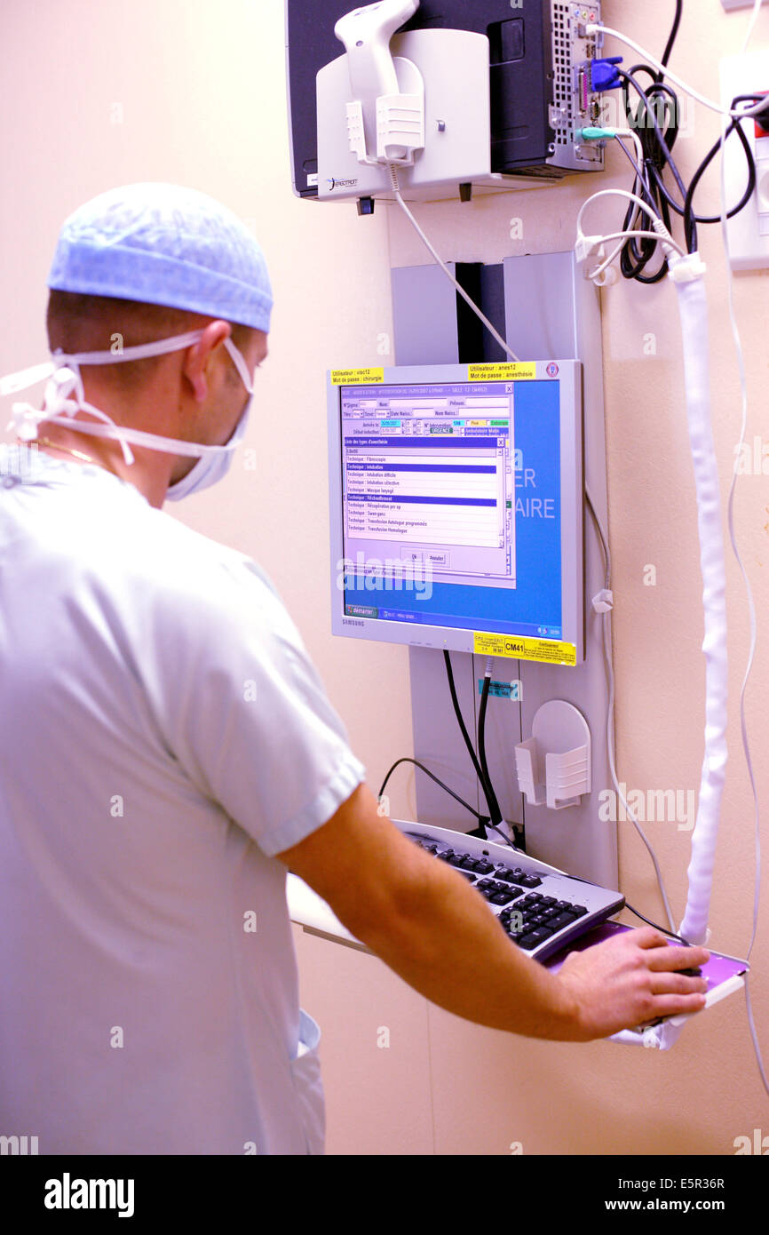 Anaesthetist checking anaesthetic monitoring datas during surgery ...