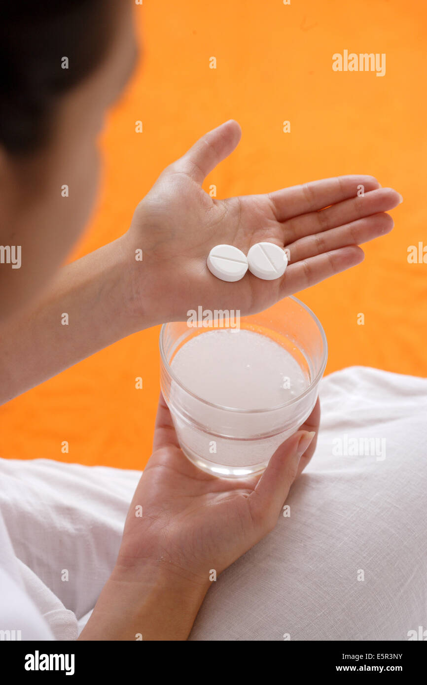 Woman taking an effervescent aspirin tablet Stock Photo - Alamy