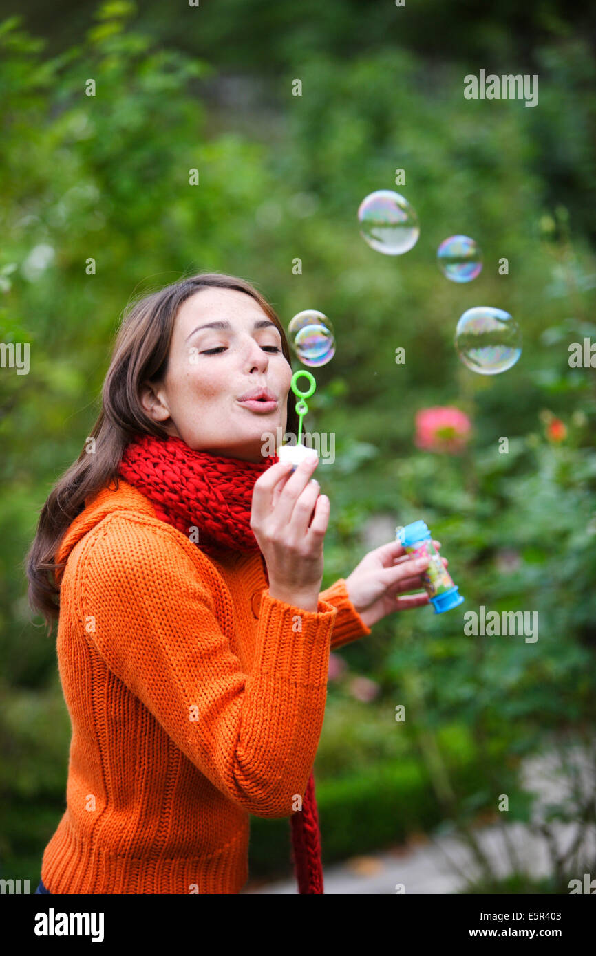 Woman making soap bubbles Stock Photo - Alamy