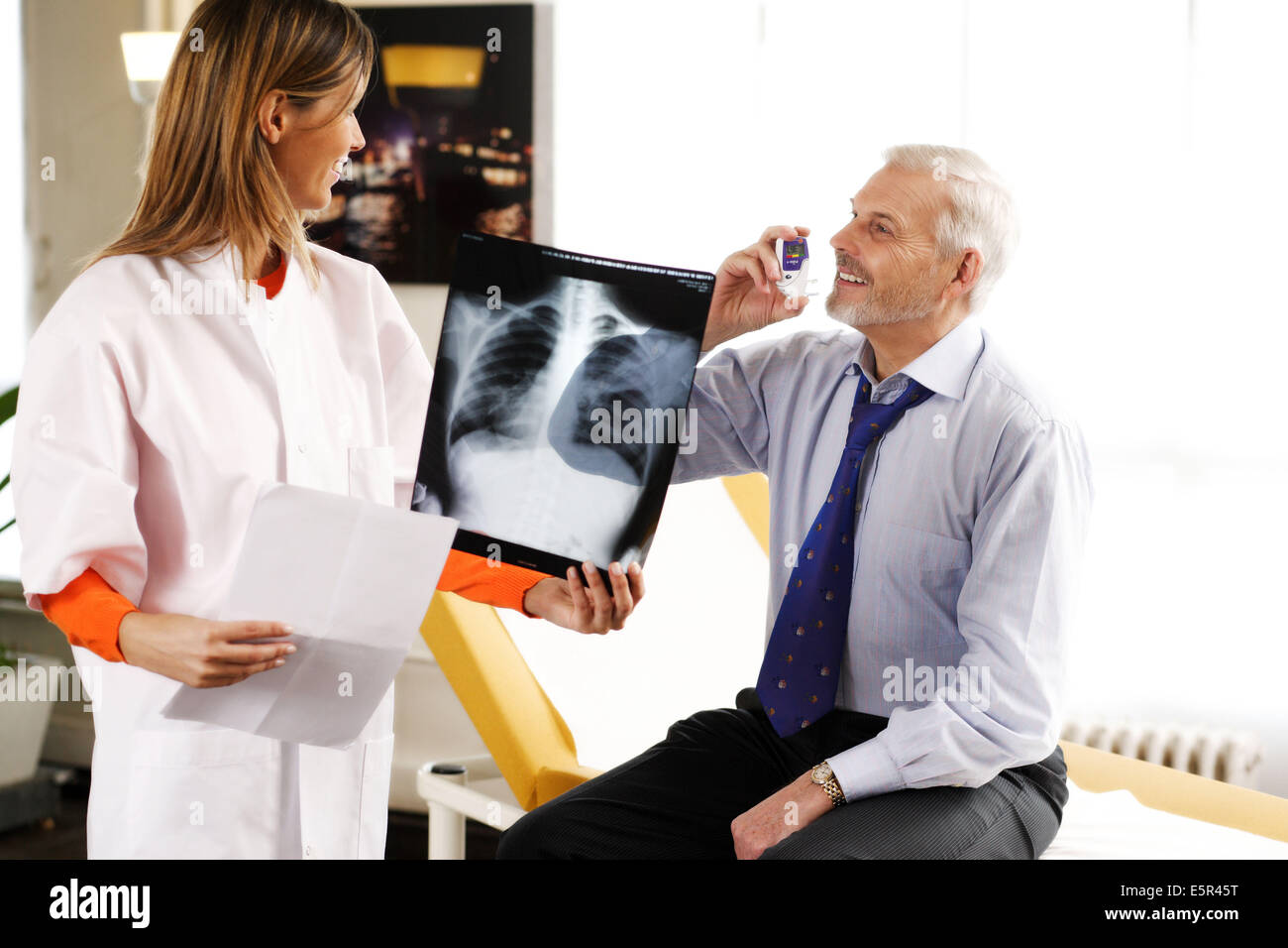 Man using a PIKO-6, a digital peak flow meter mesuring the volume of ...