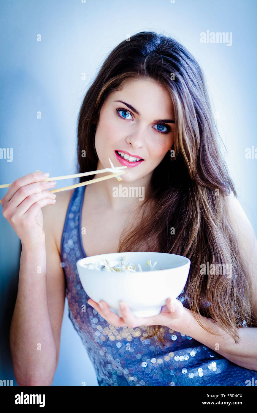 Woman eating soybean sprouts Stock Photo - Alamy