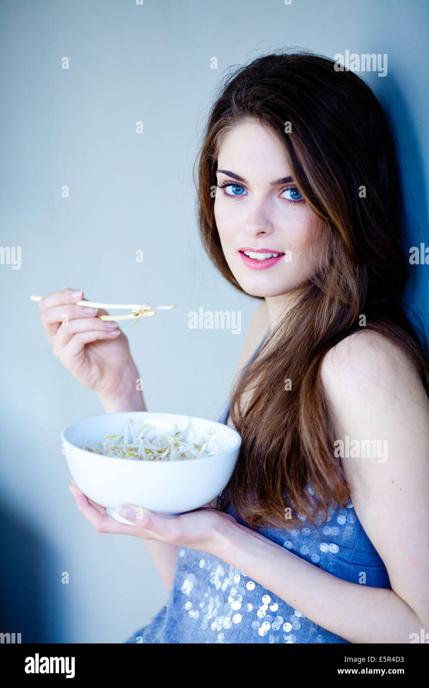 Woman eating soybean sprouts Stock Photo - Alamy