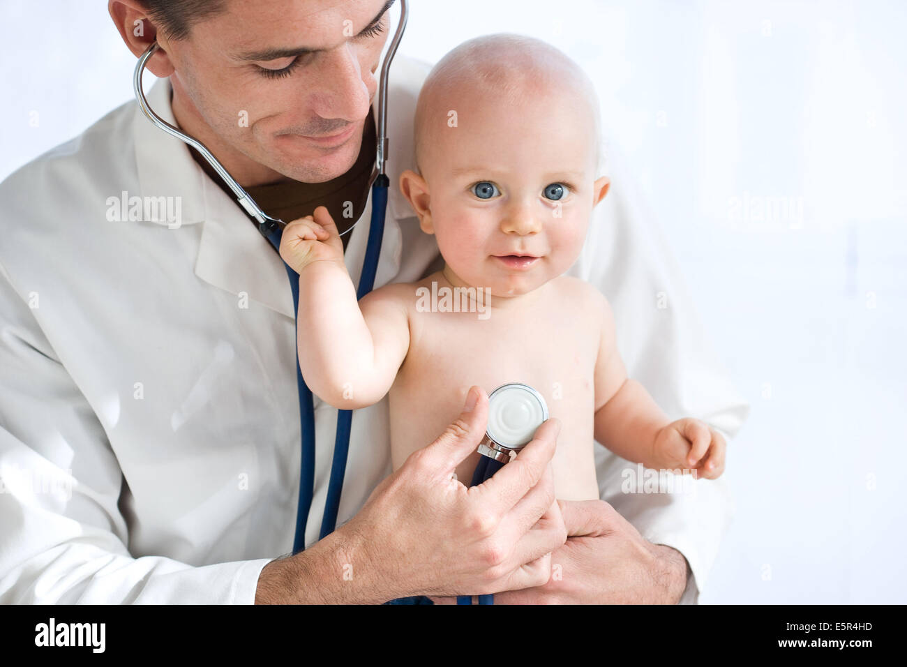 Pediatrician examining 9 month old baby with a stethoscope Stock Photo ...