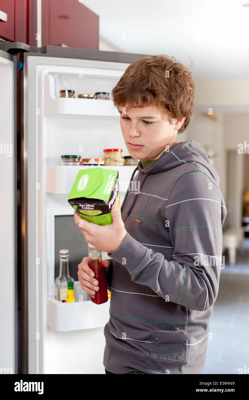 Teenager searching for food in the fridge Stock Photo - Alamy