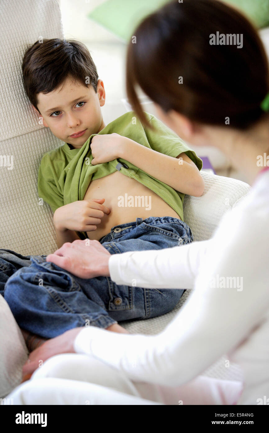8 year old child suffering from bellyache Stock Photo - Alamy