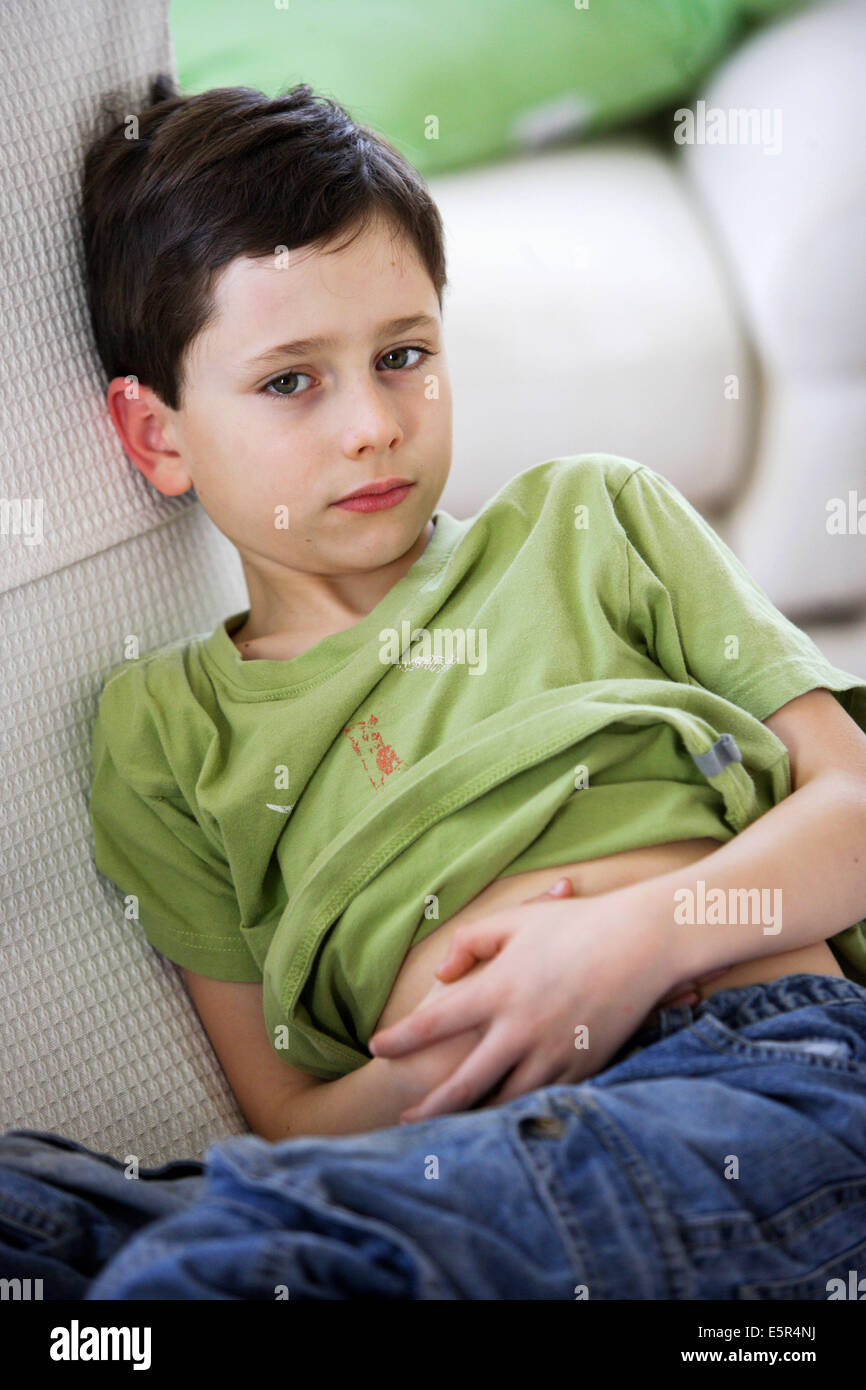 8 year old child suffering from bellyache Stock Photo - Alamy
