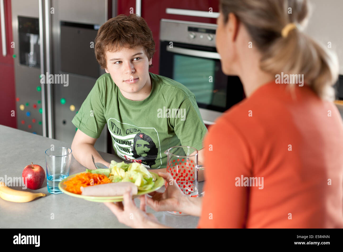 Teenager eating salad Stock Photo - Alamy