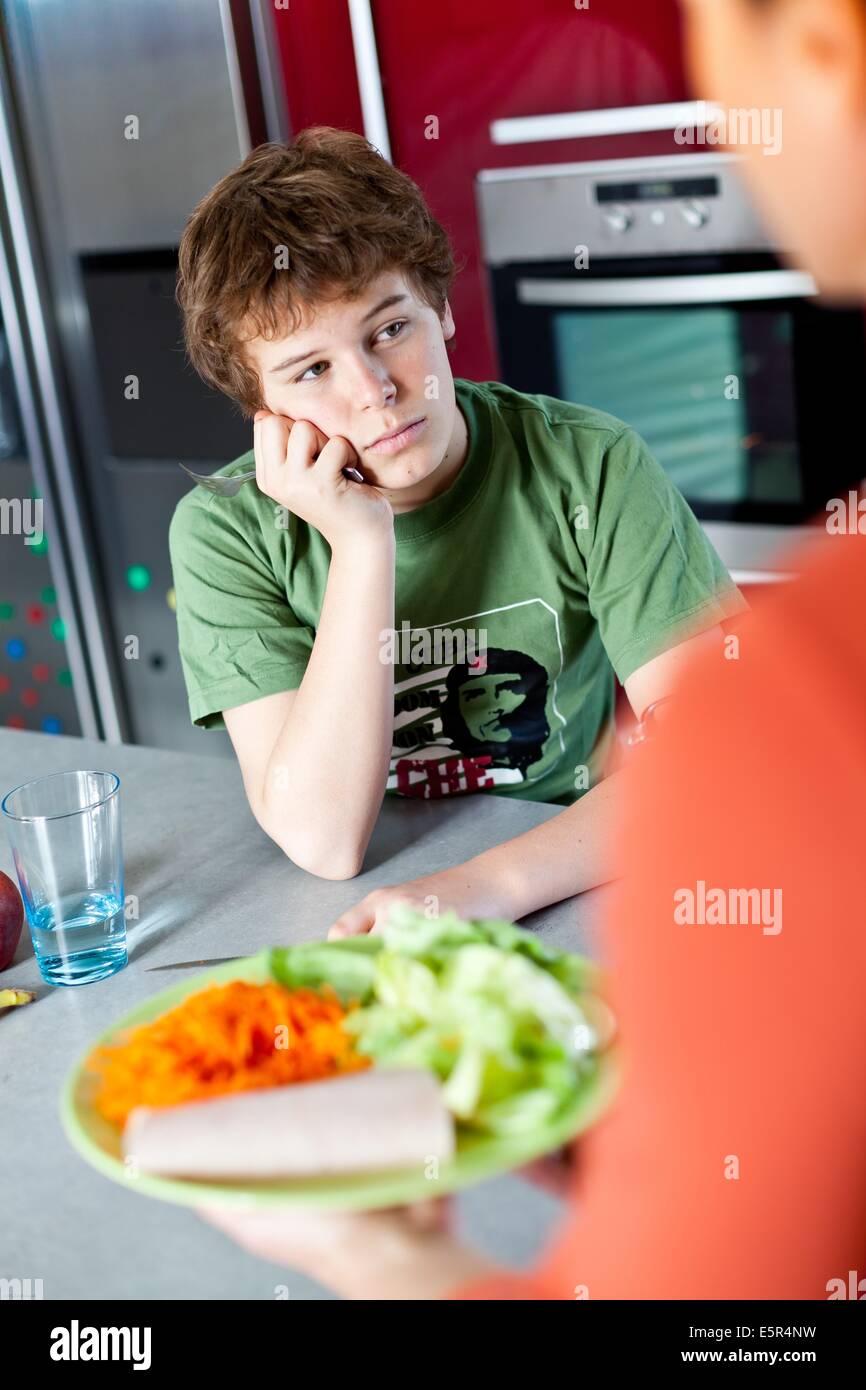 Teenager eating salad Stock Photo - Alamy