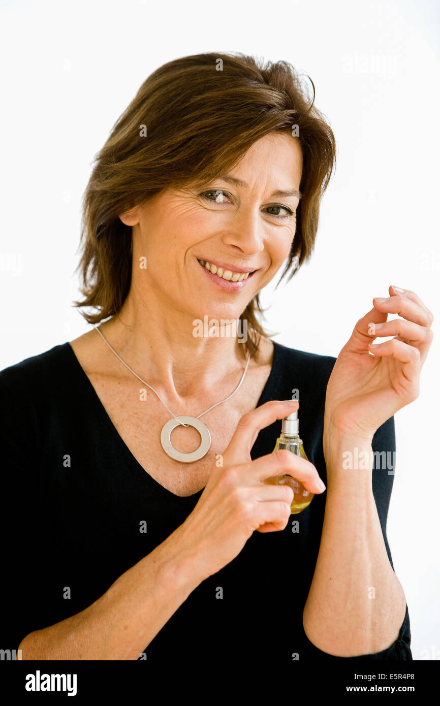 Woman applying perfum Stock Photo - Alamy