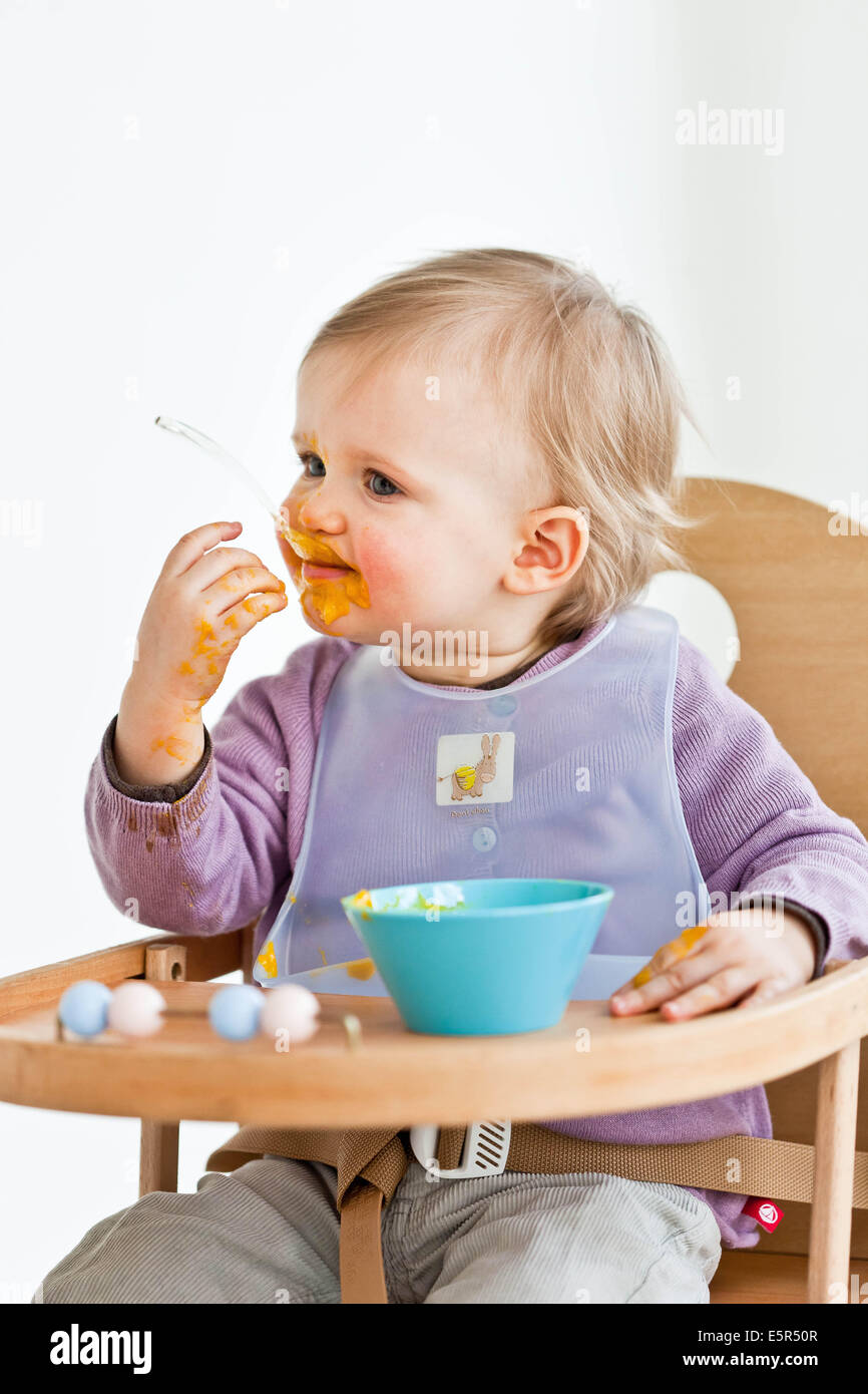 13-month-old baby girl eating alone, Independence training Stock Photo ...